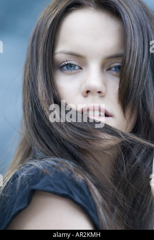 young woman grasping in her hair Stock Photo - Alamy