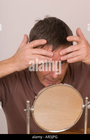 man picking spot, skin problems checking for skin problems Stock Photo ...