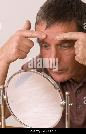 man picking spot, skin problems checking for skin problems Stock Photo ...
