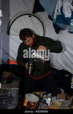 photographer Steven Kazlowski having morning coffee in the tent camp ...