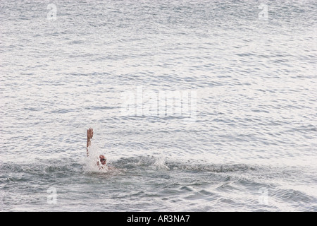 Brave swimmer entering winter sea for early morning swim Stock Photo ...