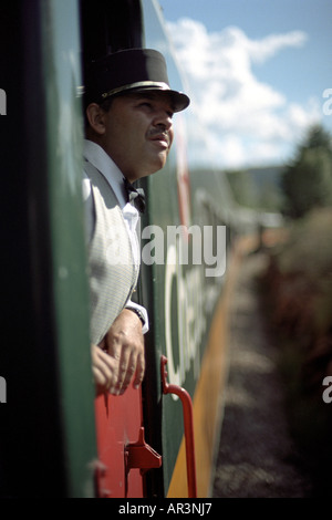 Train conductor leaning out of window of bullet train (Shinkansen ...