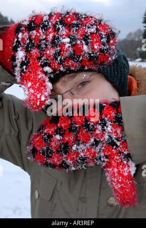 Woman showing her snow-covered mittens Stock Photo - Alamy