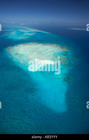 Aerial view of Upolu Cay Great Barrier Reef rising out of the Coral Sea ...