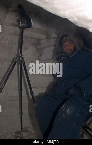 photographer Steven Kazlowski in an igloo snow blind Arctic National ...