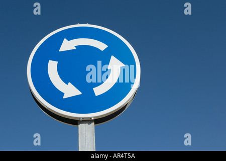 Arrows on traffic sign showing direction to drive on roundabout Stock ...