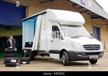Mercedes benz sprinter luton curtain sided truck speeding along a road ...