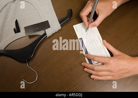 Person signing cheque Stock Photo - Alamy