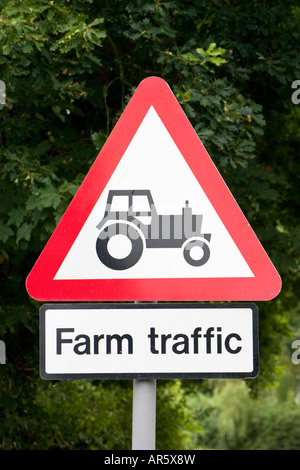 A farm vehicle traffic warning sign on a country road. Farm equipment ...