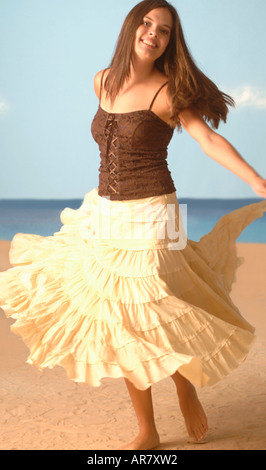 Beautiful Young Lady twirling on a Tropical Beach Stock Photo - Alamy