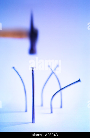 Hammer striking nail Stock Photo - Alamy