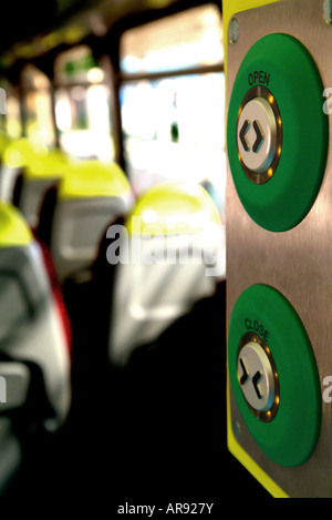Button for opening doors on the train. Close-up of female hands on the ...