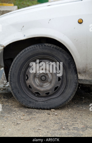 bent wheel rim car hit a pothole old car Stock Photo - Alamy