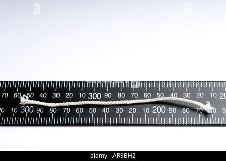 Image of a piece of string being measured against a ruler Stock Photo ...