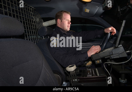 Police Officer using notebook laptop computer in car Stock Photo - Alamy