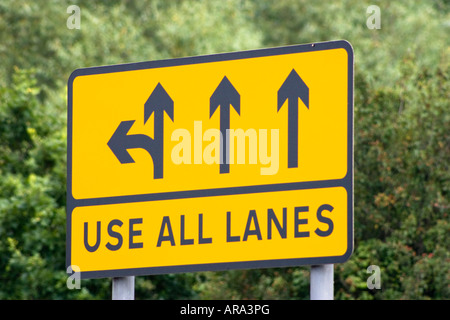 A Yellow Traffic Sign With Three Arrows In A Circle Against A Blue Sky; Calgary, Alberta, Canada ...
