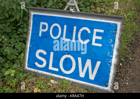 A mobile "Police Slow" sign Stock Photo - Alamy