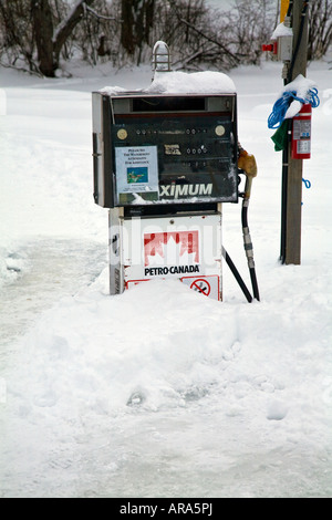 A gas pump frozen with ice and snow - frozen gas prices concept Stock ...