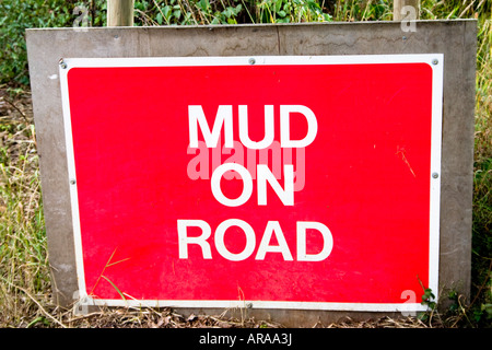 'Caution Mud on Road' sign on an empty Norfolk country lane Stock Photo ...