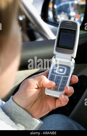 Woman sending sms on cellphone Stock Photo - Alamy