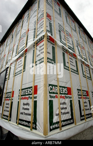 Timber framed building clad completely with plastic on construction ...