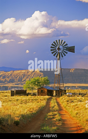 USA Utah Old farm windmill and Church Rock in high desert south of Moab ...