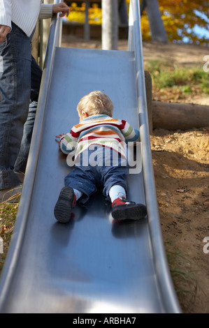 baby sliding down the slide on the playground Stock Photo - Alamy