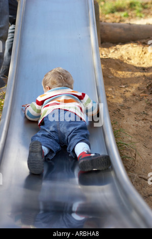 baby sliding down the slide on the playground Stock Photo - Alamy