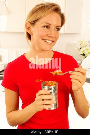 GIRL EATING BAKED BEANS FROM TIN CAN Stock Photo - Alamy
