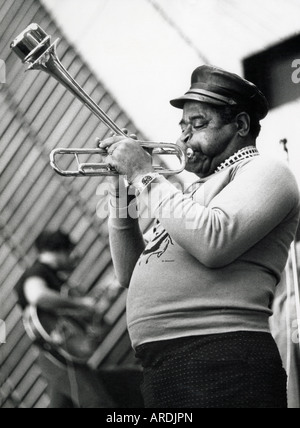 American jazz musician Dizzy Gillespie puffing out his cheeks during a ...