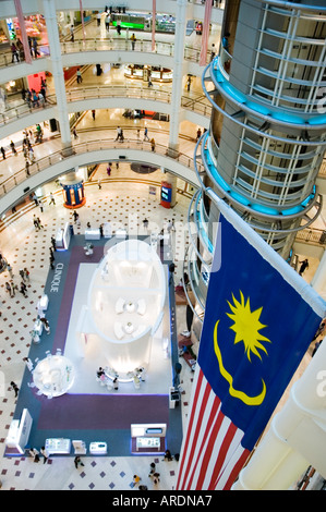 Shoppers walk through the many levels of the KLCC Suria shopping mall ...