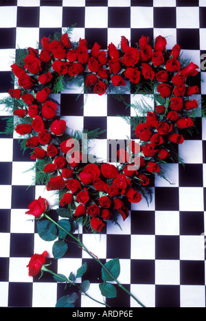 Heart shaped wreath of red roses on door Stock Photo - Alamy