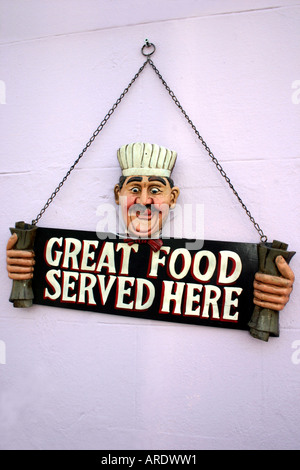 'Great Food Served Here' sign hanging on wall outside cafe in village ...