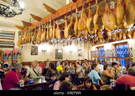 Serrano hams hanging from the ceiling in tapas bar in Sevilla Andalucia ...