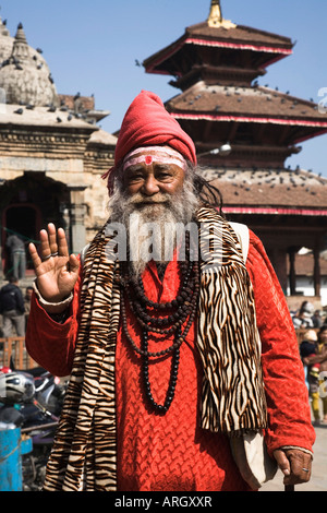 Portrait of a sadhu standing on one leg on the support of swing at Maha ...