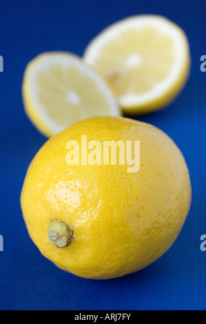 Sliced citrus on blue background. Orange, lemon and lime Stock Photo ...