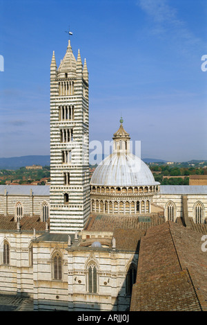 Vertical shot of a building with a turret roof surrounded by mountains ...