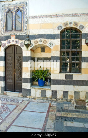 Beautiful black window grille made of iron on a sunny day Stock Photo ...