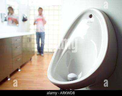A man standing peeing to urinal in the restroom Stock Photo - Alamy