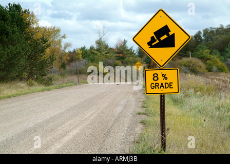 Traffic sign alerting motorist drivers that paved highway turns into a ...