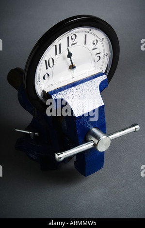 Clock in vice grips Stock Photo - Alamy