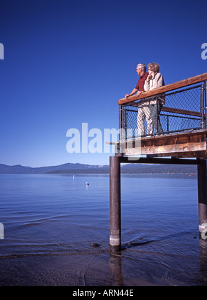 Senior couple looking out at lake Stock Photo - Alamy