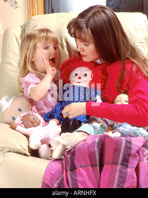 Mother and girl talking about dolls Stock Photo - Alamy