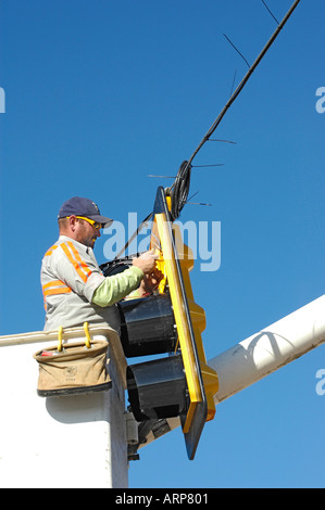 Electrician working on new turn signals on highway for better traffic ...