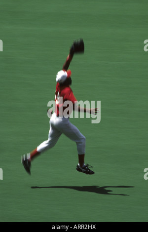 Sports, action and a men catch baseball, jump in air with ball in ...