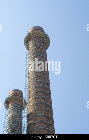 Two tall brick chimneys at an industrial site Stock Photo - Alamy