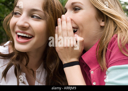 Two teenage girls gossiping Stock Photo - Alamy