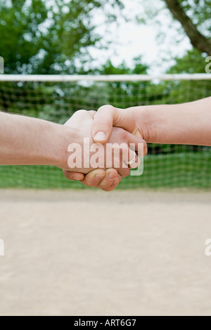Two footballers are shaking hands Stock Photo - Alamy