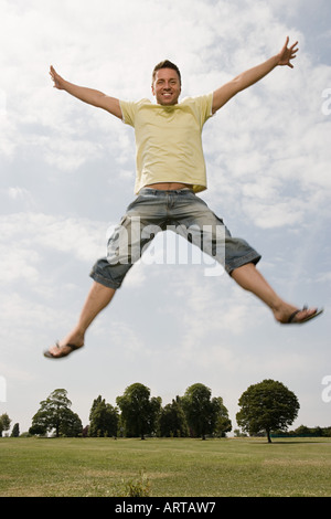 Man star jumping Stock Photo - Alamy