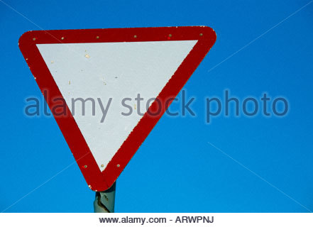 A blank inverted triangle road sign (meaning "Yield") in Bourglinster ...
